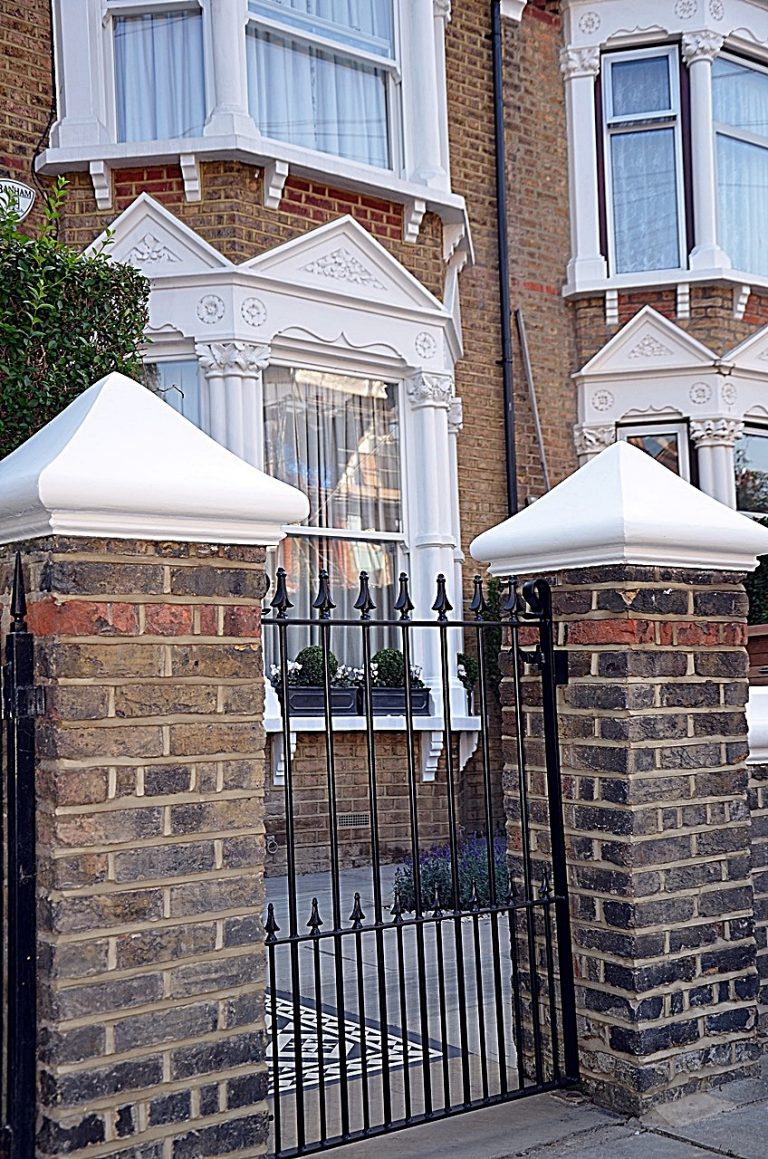 Brick garden wall cap coping white colour iron gate rails path paving ...